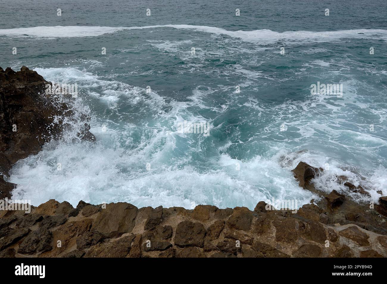 Waves breaking on the shore on a pebble road Stock Photo - Alamy
