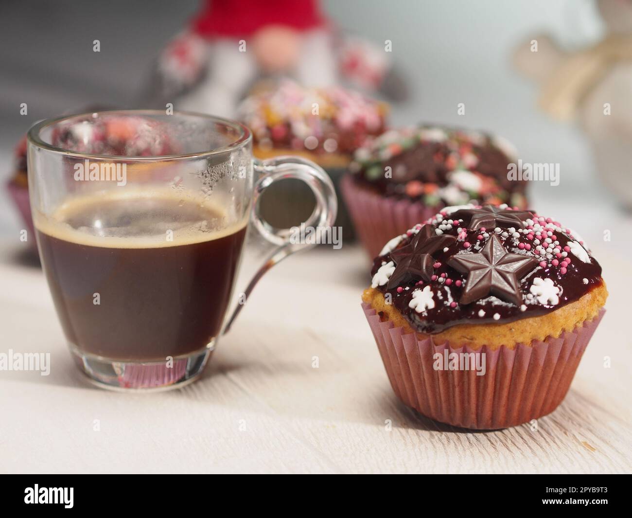 Cupcake with chocolate stars and coffee in front of gnome and snowman ...