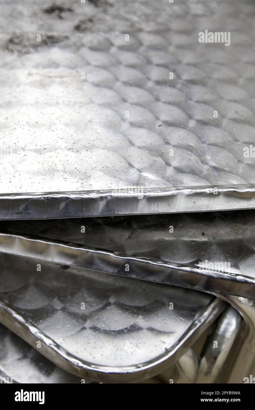 Wet metal tables Stock Photo - Alamy