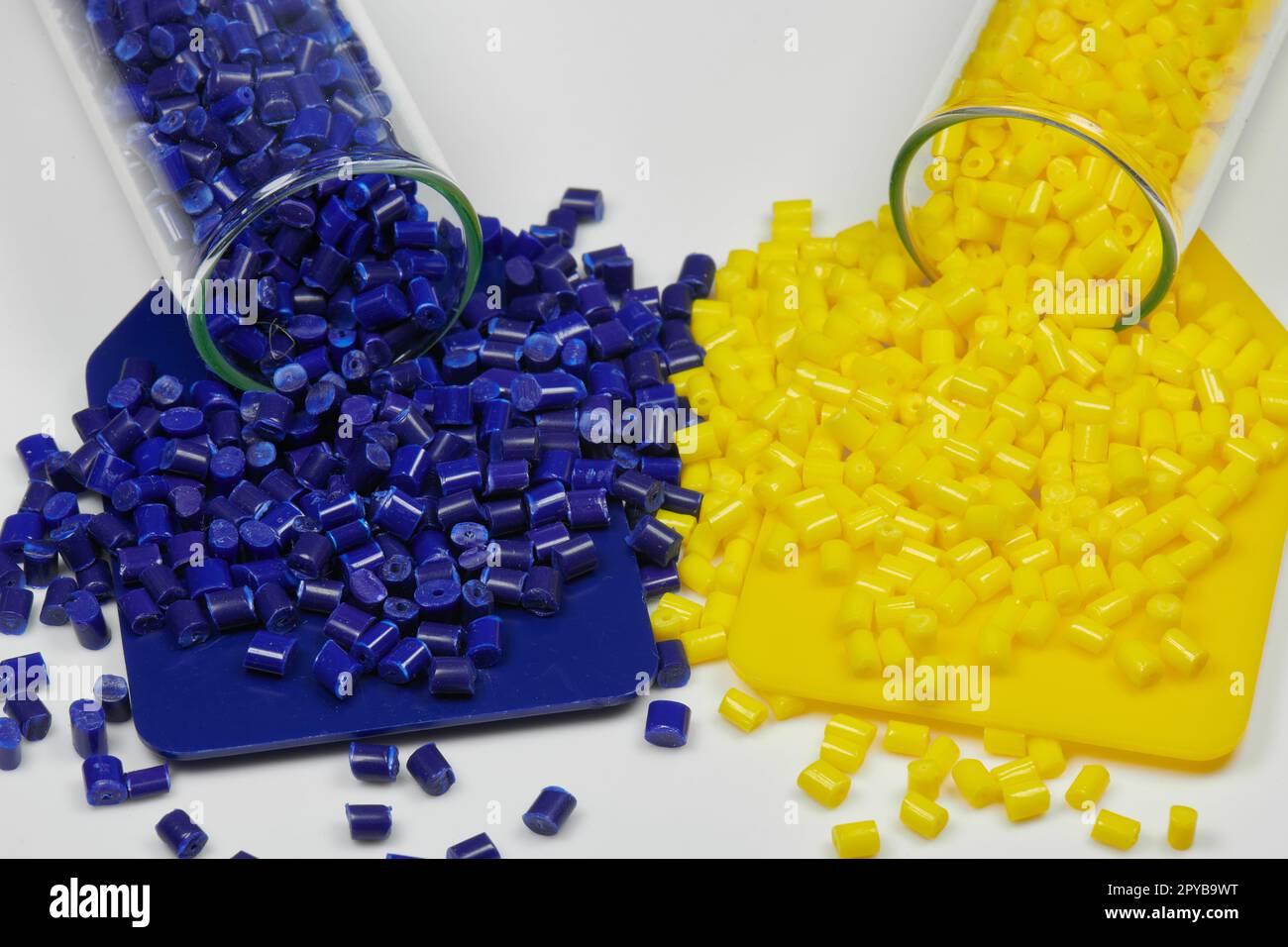 blue and yellow colored plastic resins in test tubes in laboratory with ...