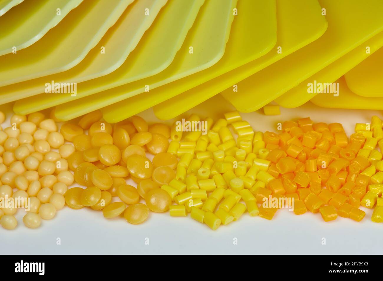 different yellow plastic polymer resin granulates with color samples in ...