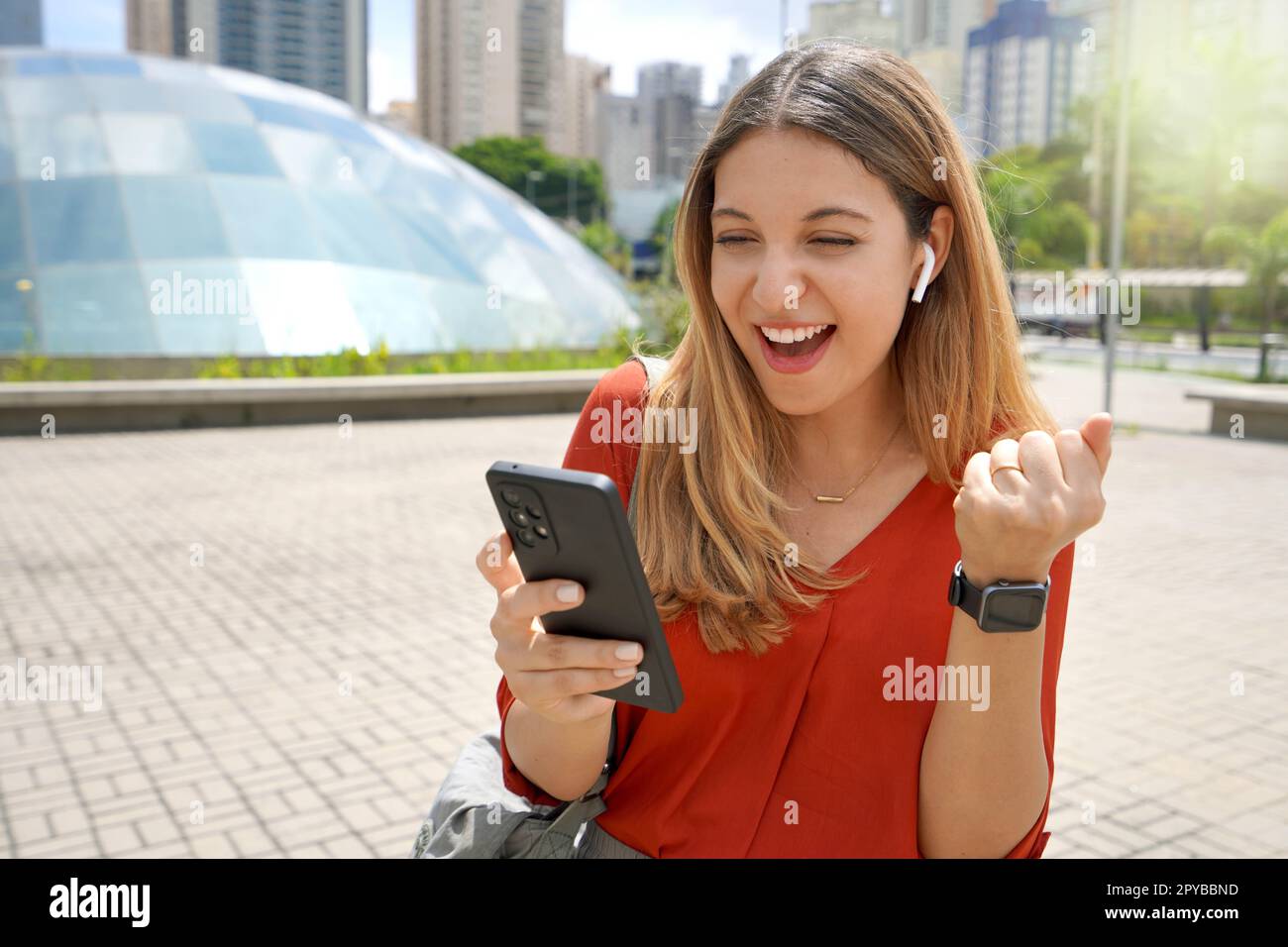 Joyful excited young woman screaming enjoying her favorite song on ...