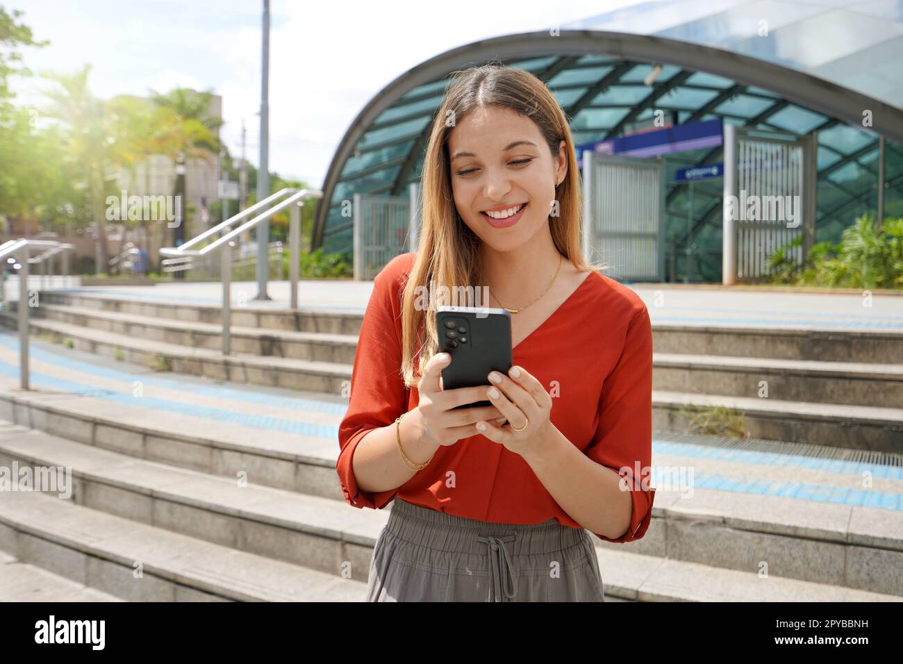Beautiful native digital girl using mobile phone in the city Stock ...