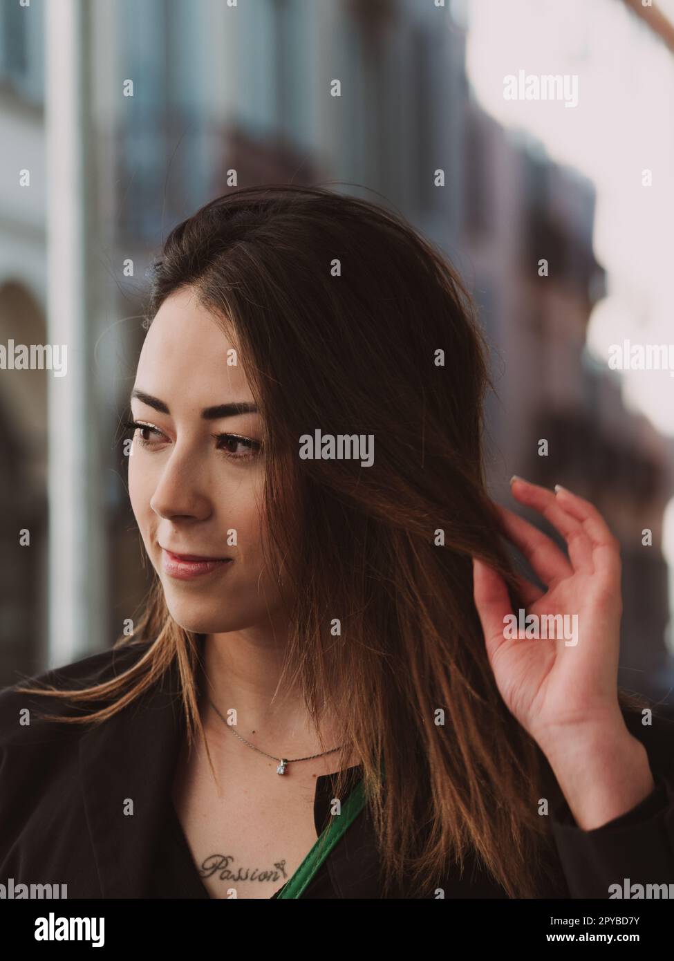 street portrait of long haired brunette standing outdoors, mixed asian ...