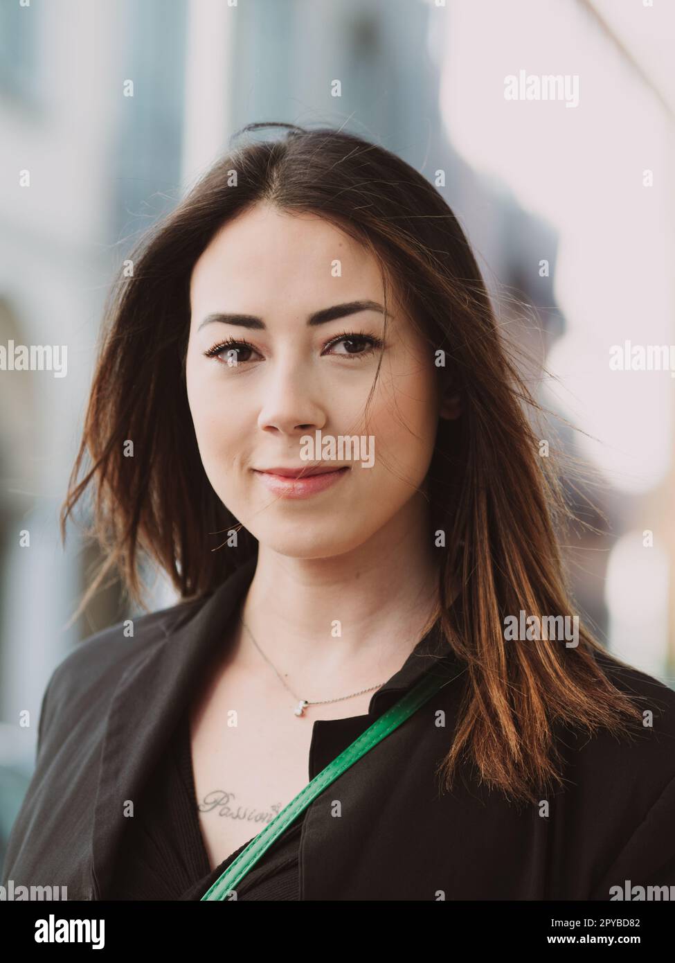 street portrait of long haired brunette standing outdoors, mixed asian ...