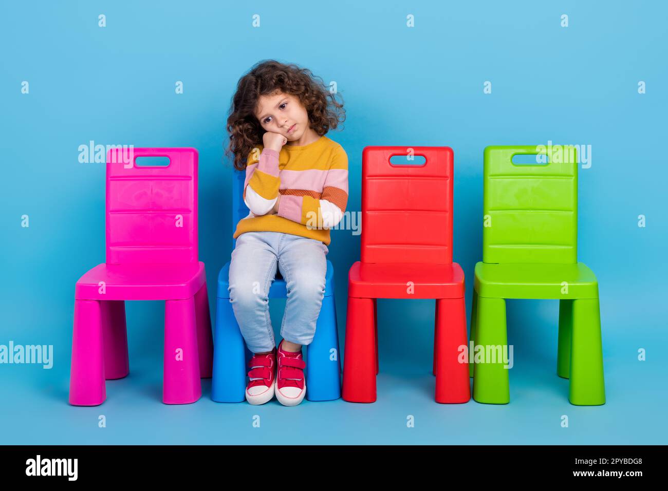 Full body cadre of offended sad preschool girl brown curly hairstyle ...