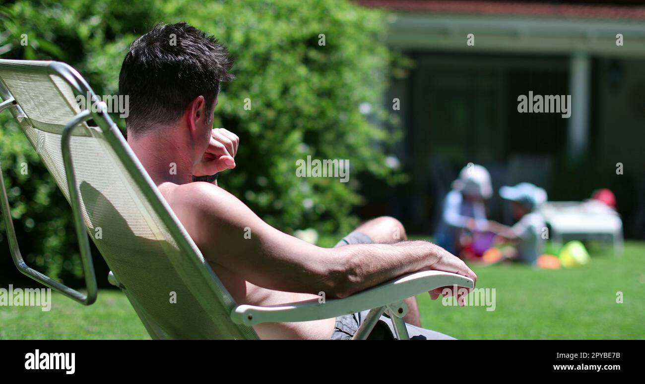 Pensive man resting outside in backyard home garden thinking Stock ...