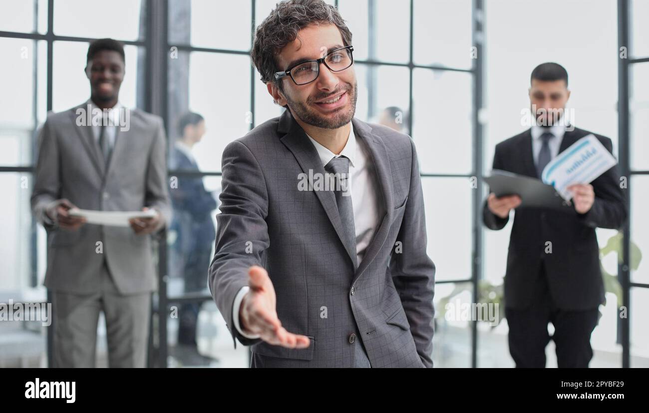 business and office concept - handsome buisnessman with open hand ready ...