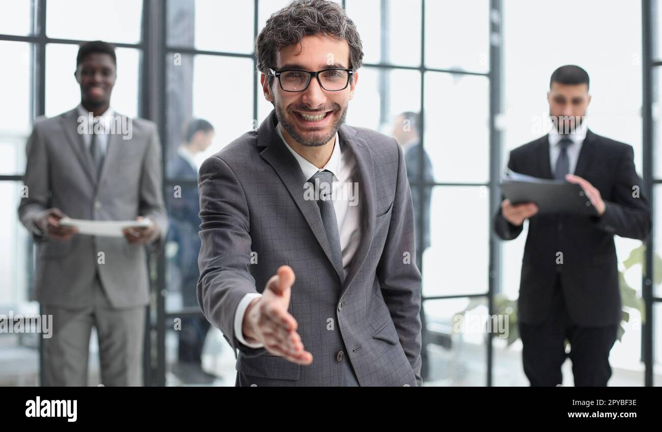 business and office concept - handsome buisnessman with open hand ready ...