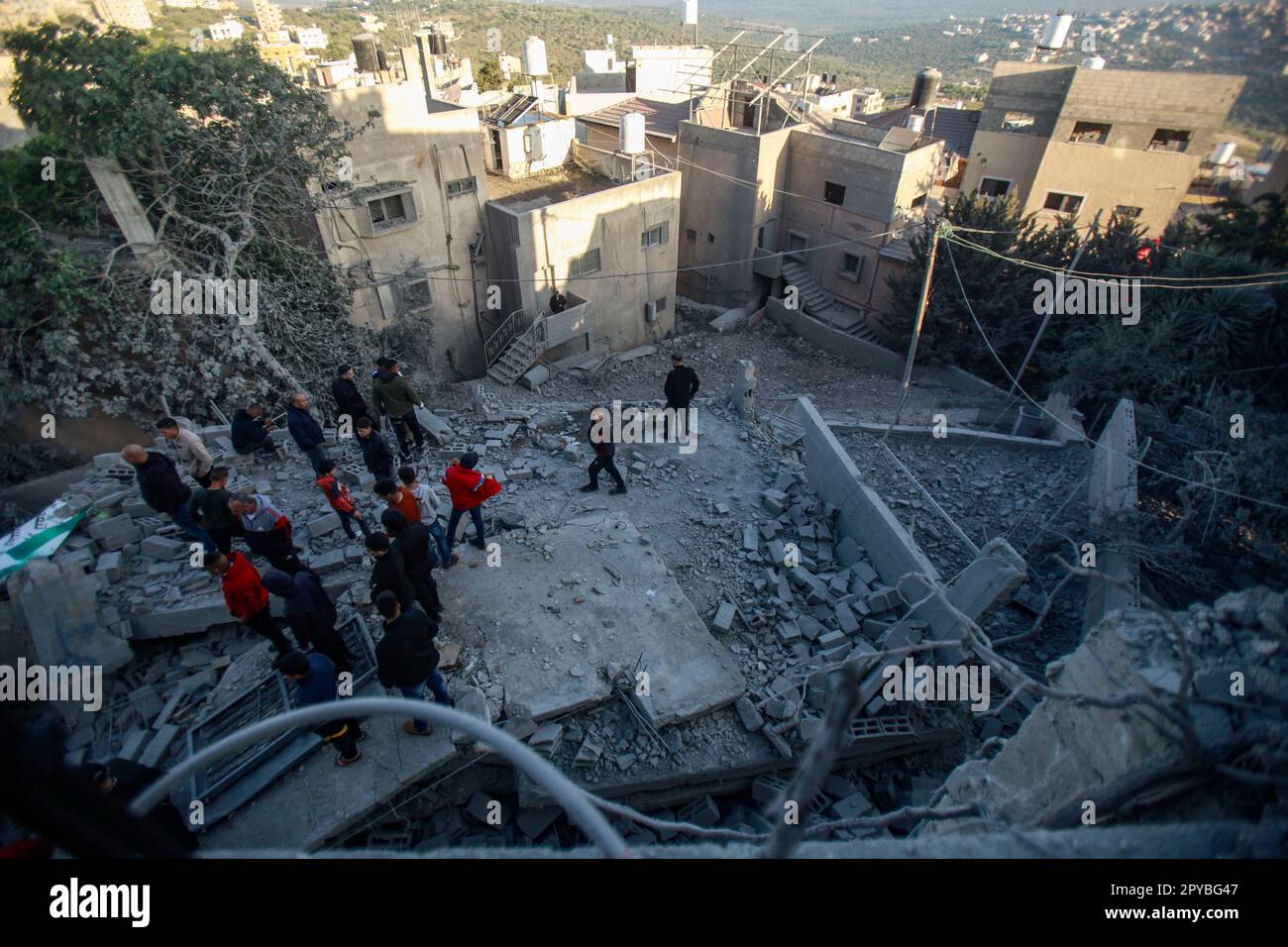 Palestinians inspect the ruins of the house of Palestinian militant ...