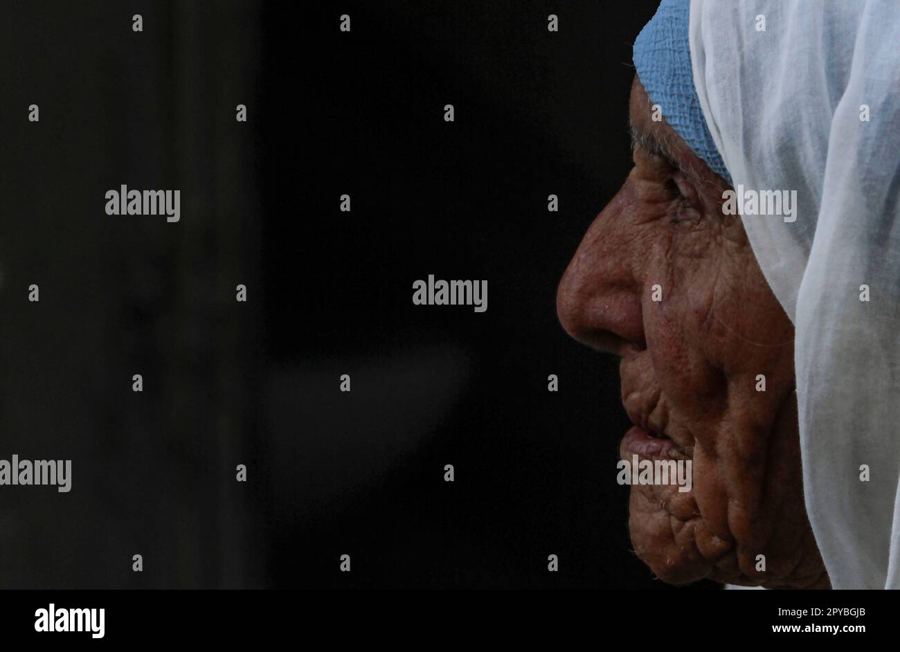 Ayush, the grandmother of Palestinian Mohammed Souf, looks at the ruins ...