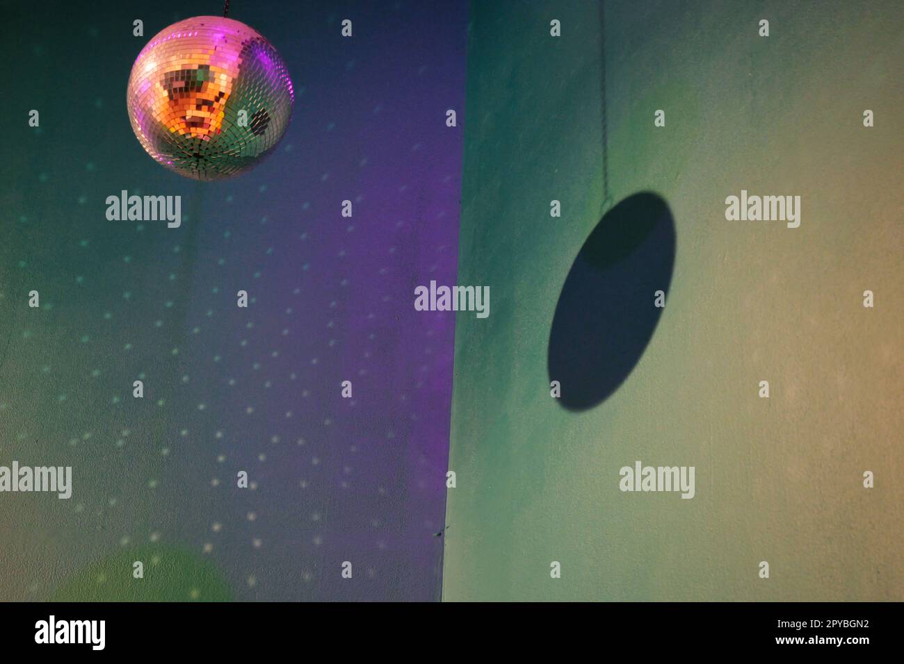 A disco ball looking at its own shadow while reflecting on the dance ...