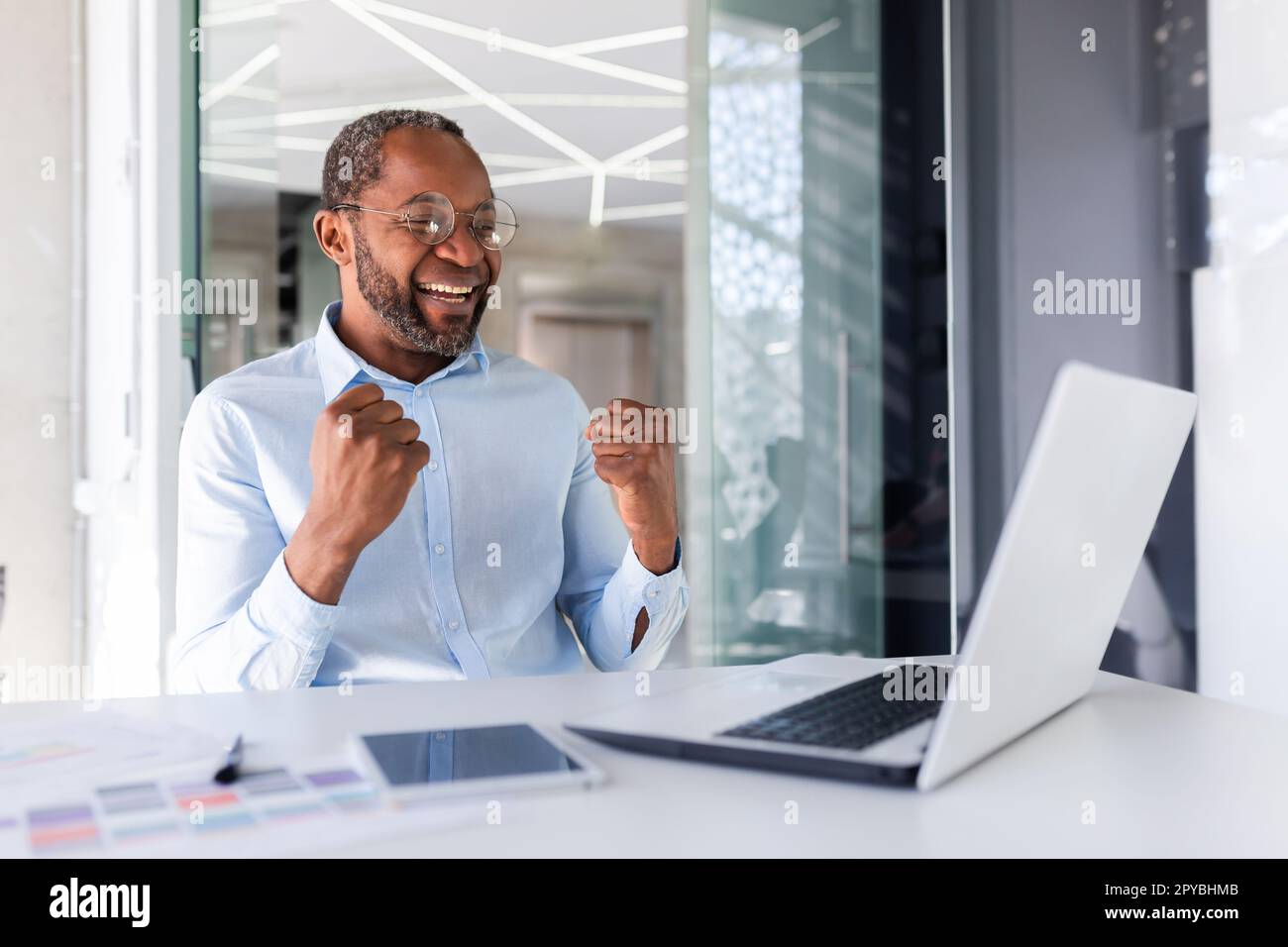 Successful man working inside office, man holding hands up gesture of ...