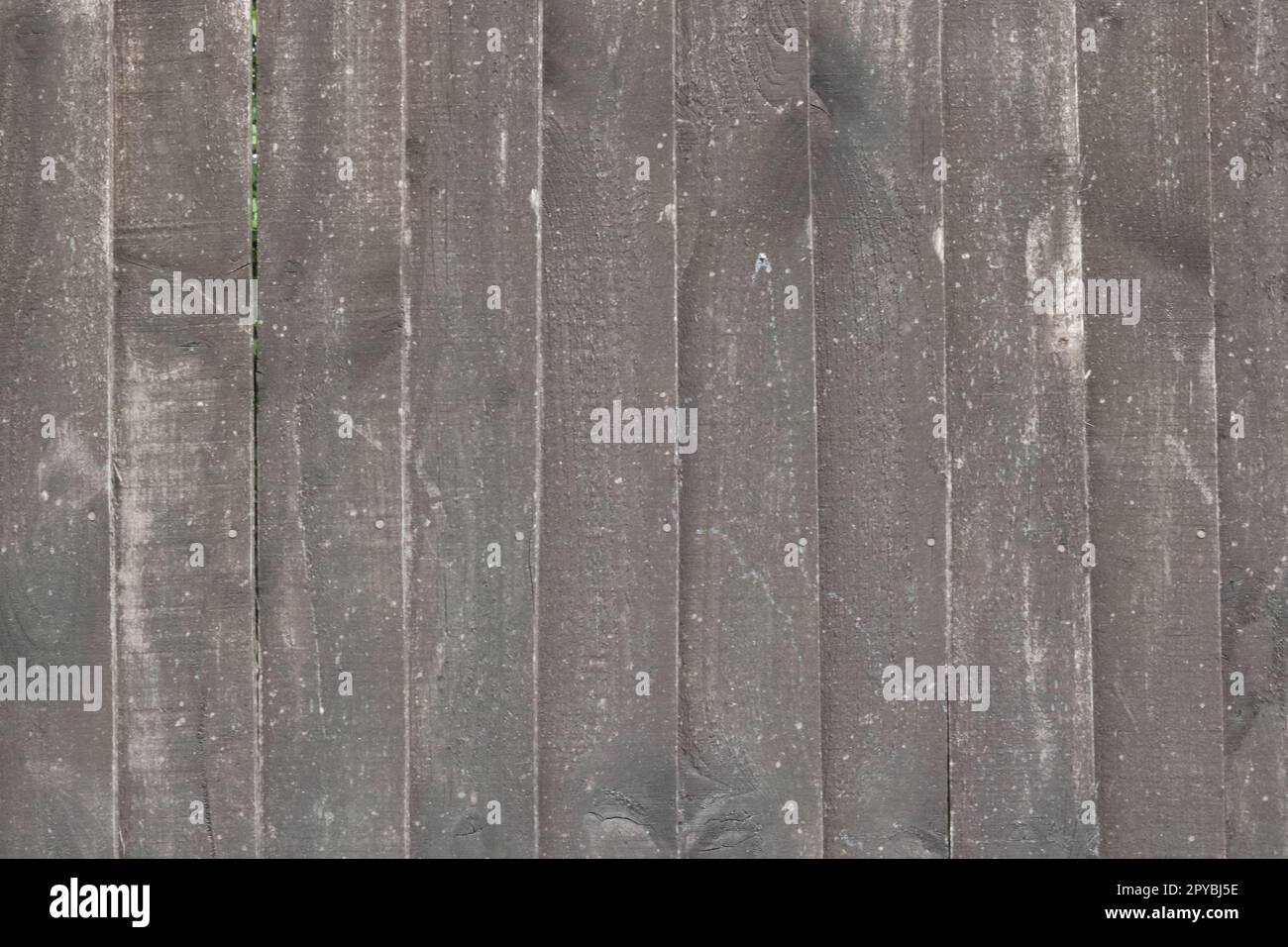 Wooden vertically panelled weathered old fence background with space ...
