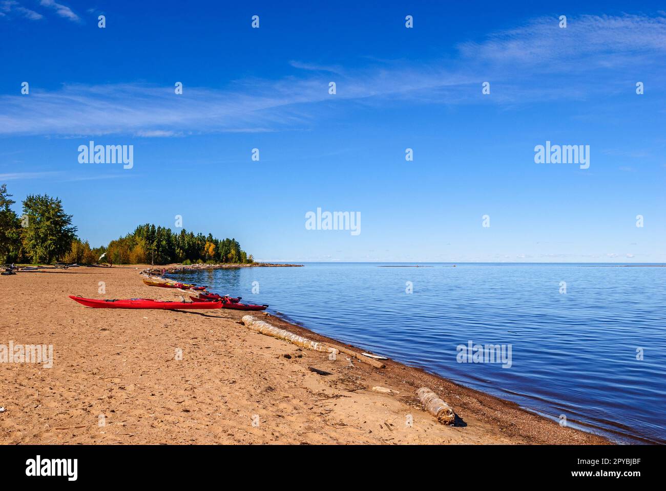 Kayaks pulled up on a sandy beach along the shore of Great Slave Lake ...