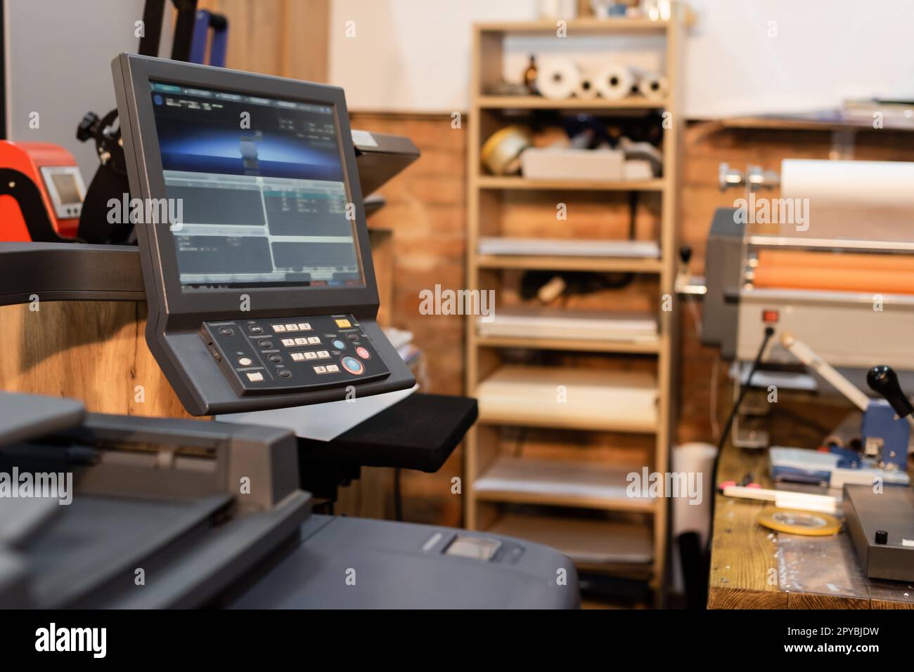 modern printer next to monitor and button panel in print center,stock ...