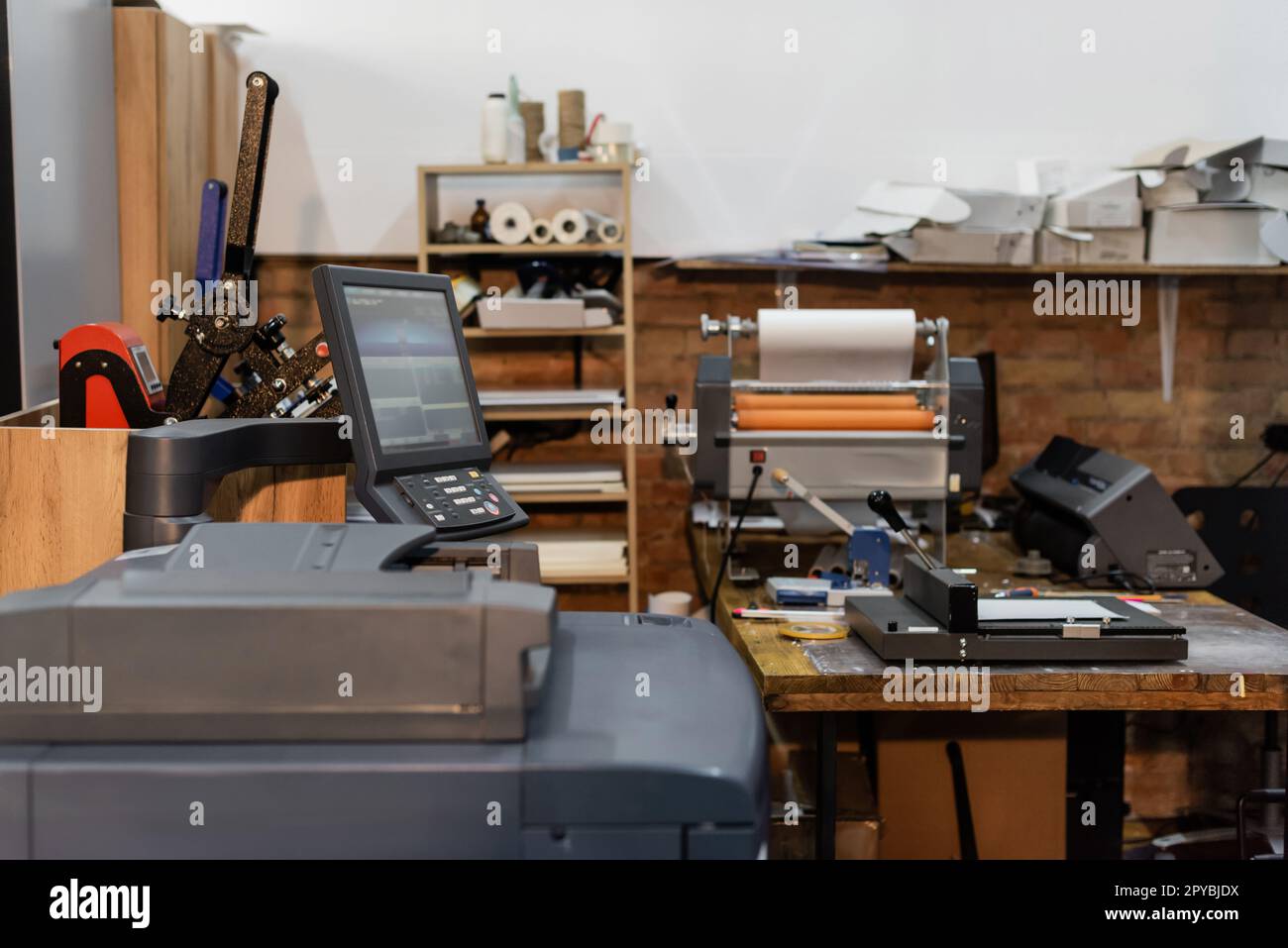 modern print center equipment next to monitor and paper trimmer,stock ...