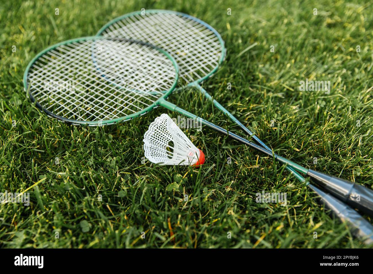 badminton rackets and shuttlecock on grass Stock Photo - Alamy