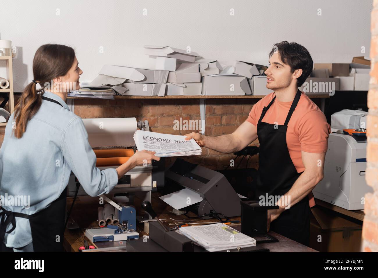 good looking man giving newspaper with economic news lettering to ...