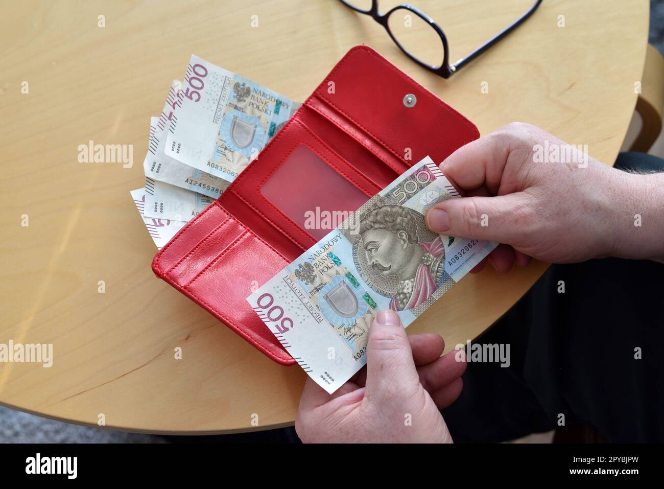 Hands holding wallet with polish currency money. Concept of financial ...