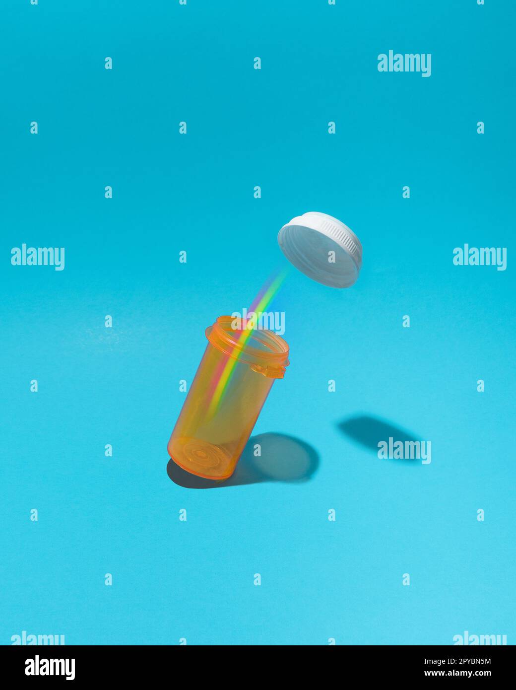 Orange medication prescription bottle with the lid popping off and a ...