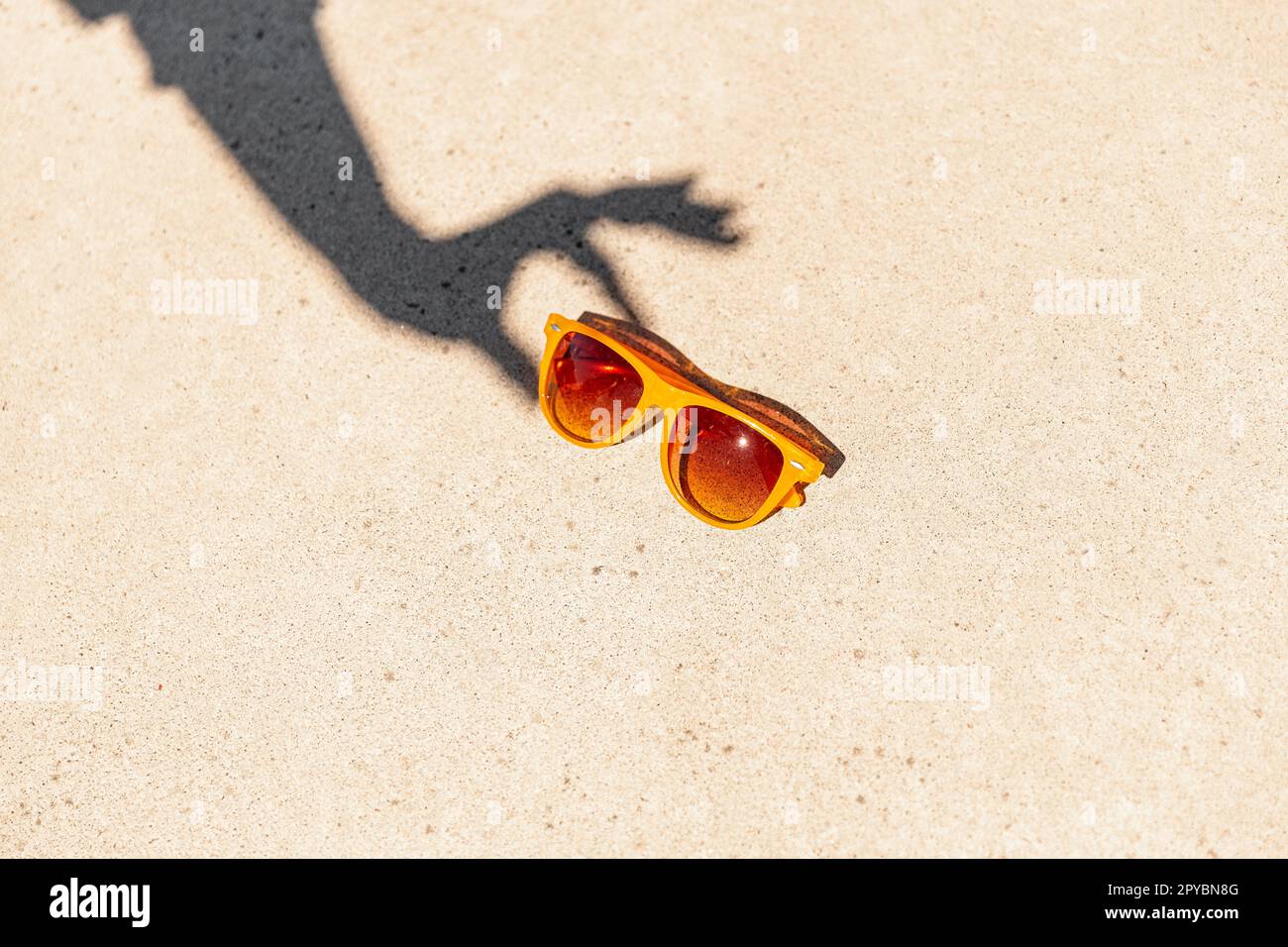 shadow of hand holding real sunglasses Stock Photo - Alamy