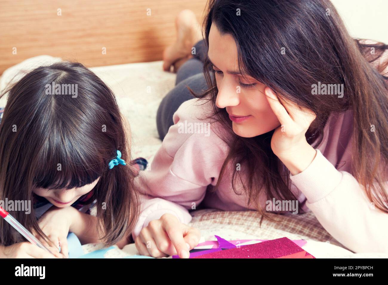 Mom with the daughter reading together Stock Photo - Alamy