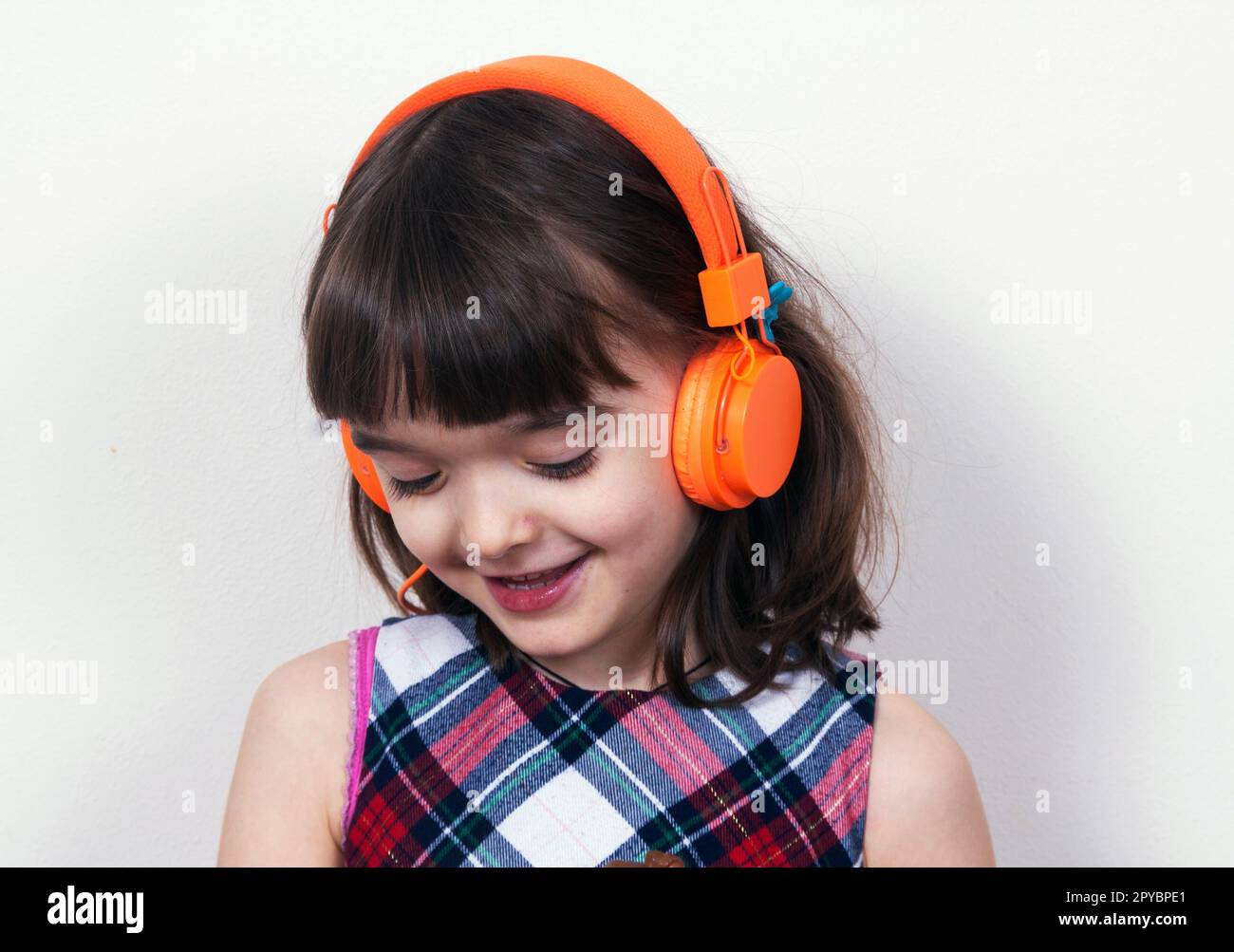 Little girl using the earphones Stock Photo - Alamy