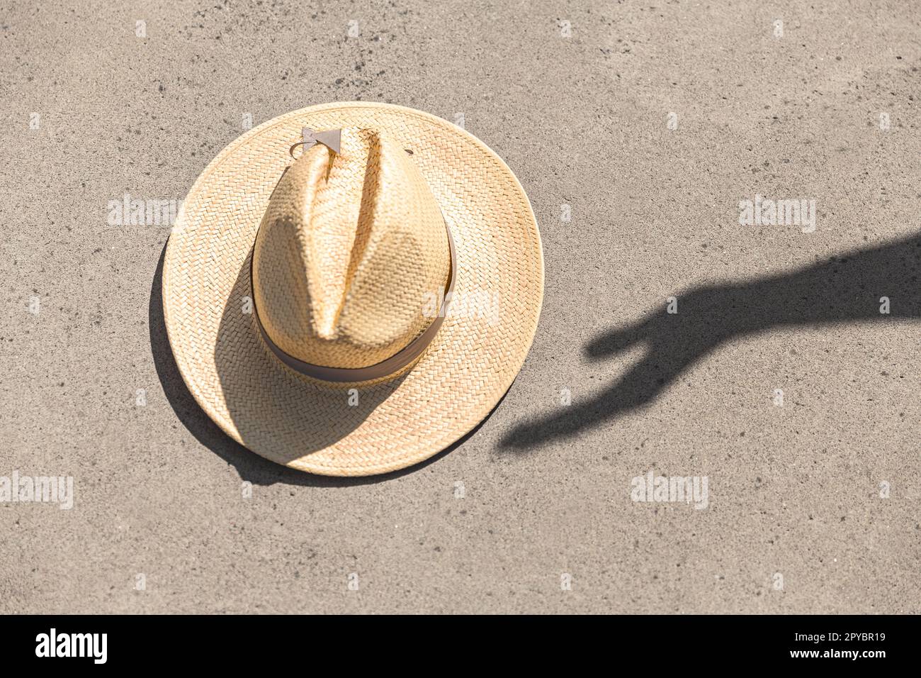 shadow of hand touching real straw hat Stock Photo - Alamy