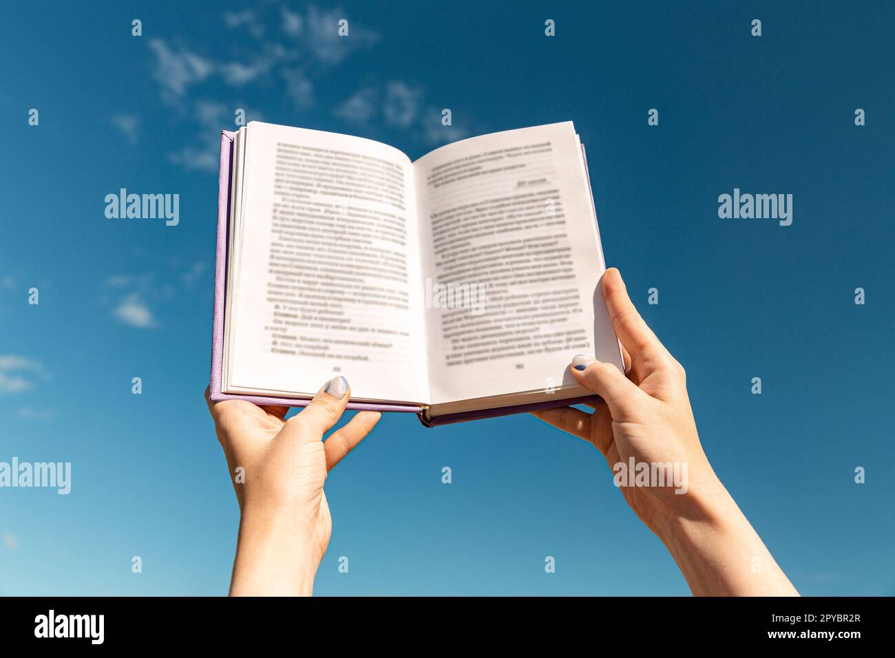 Hands book reader blue hi-res stock photography and images - Alamy
