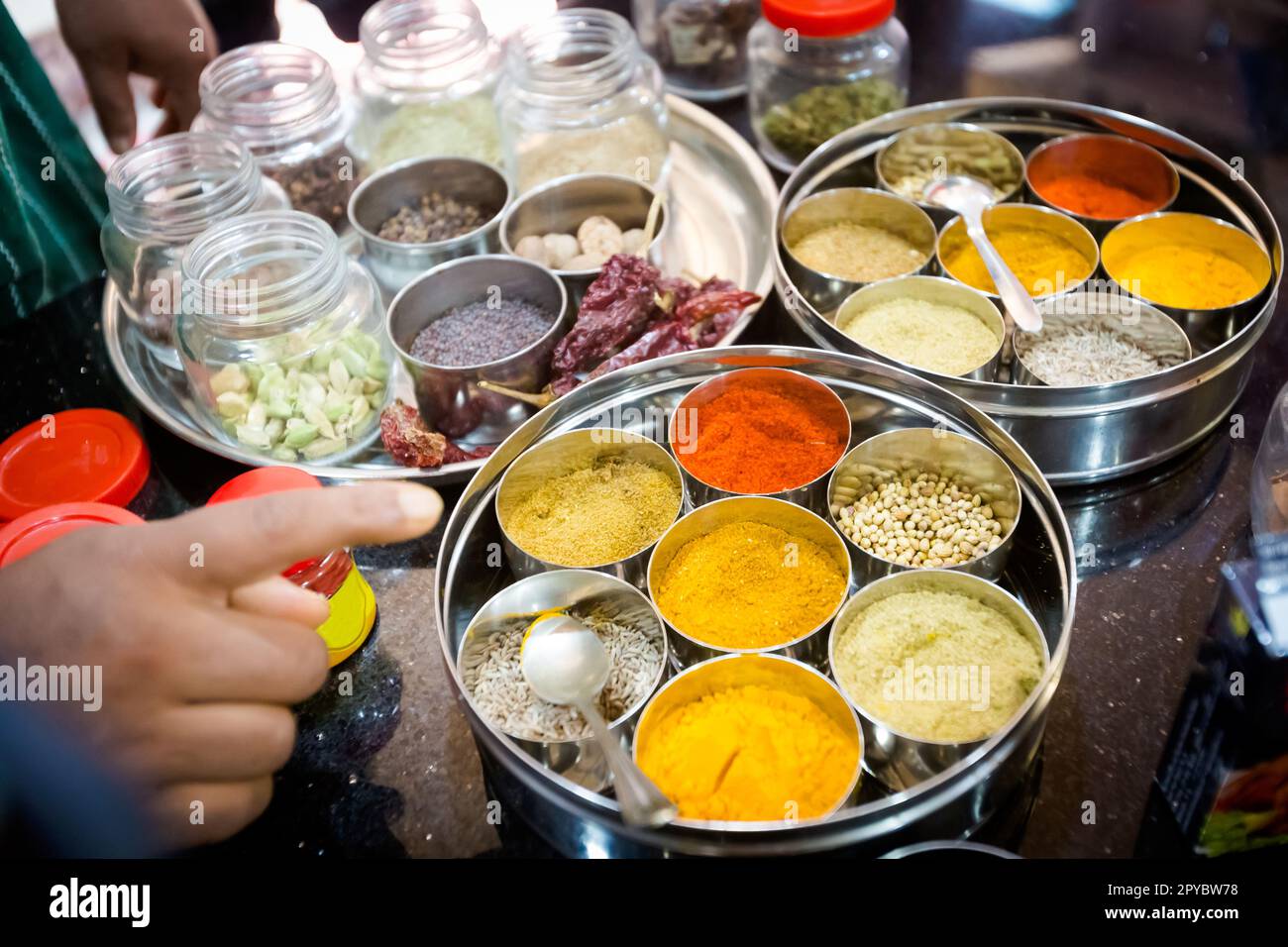 Traditional way of preparing indian food - fresh herbs and spices ...
