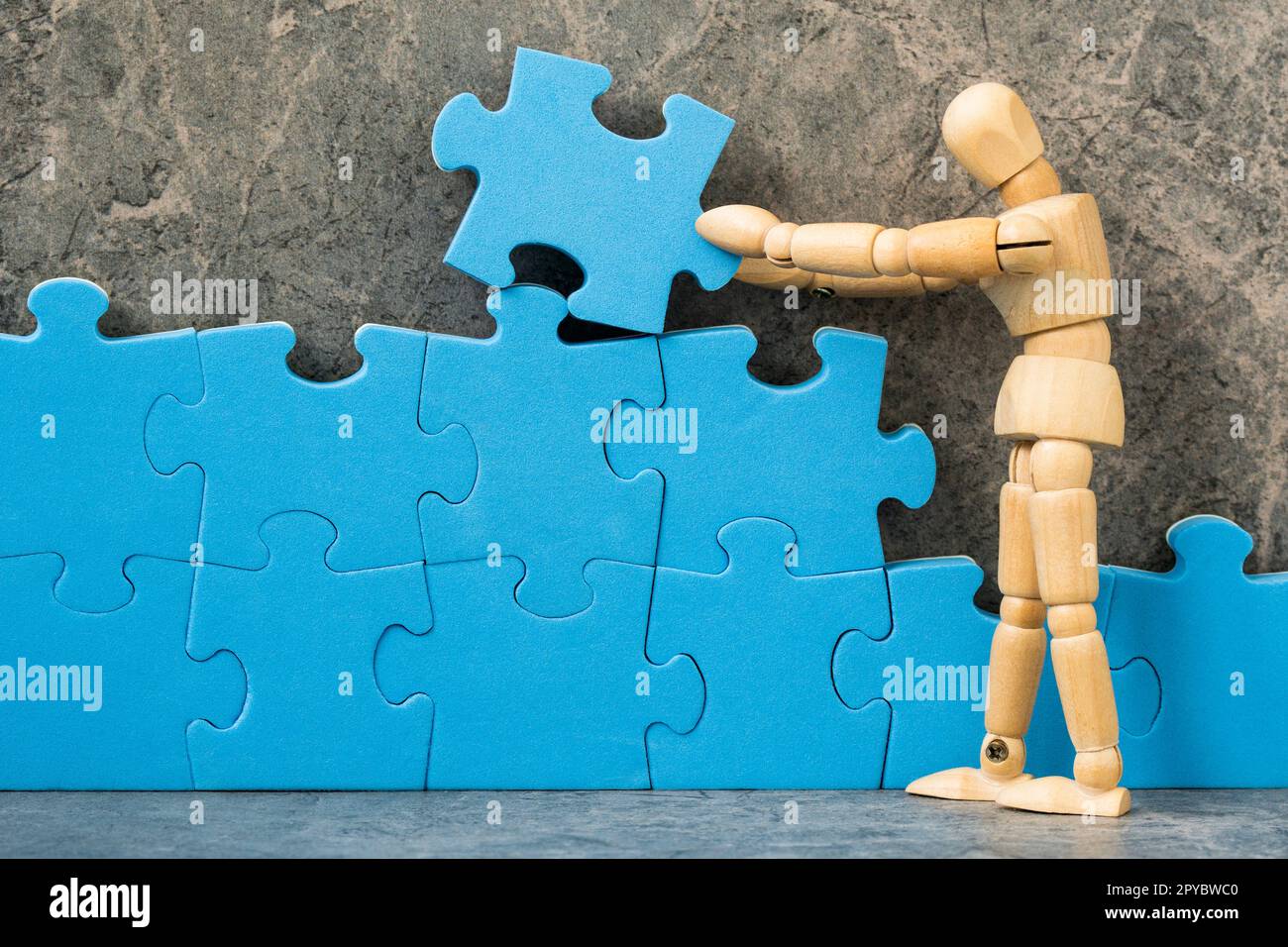 Dummy building blue puzzle. Creating or building own business concept ...