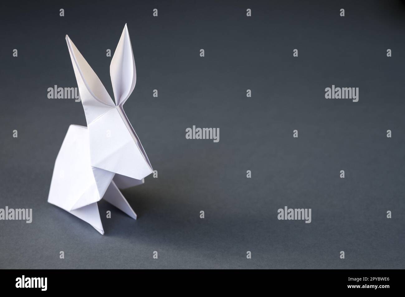 White paper rabbit origami isolated on a grey background Stock Photo ...