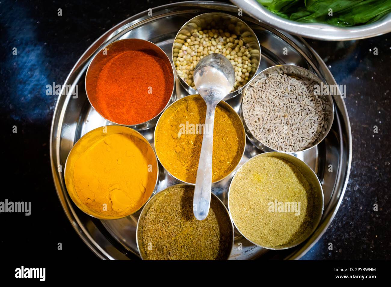 Traditional way of preparing indian food - fresh herbs and spices ...
