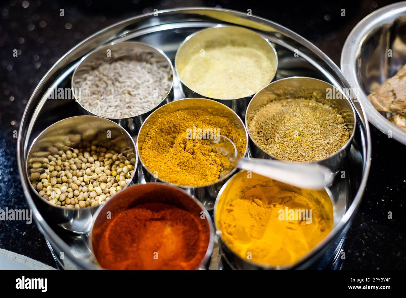 Traditional way of preparing indian food - fresh herbs and spices ...