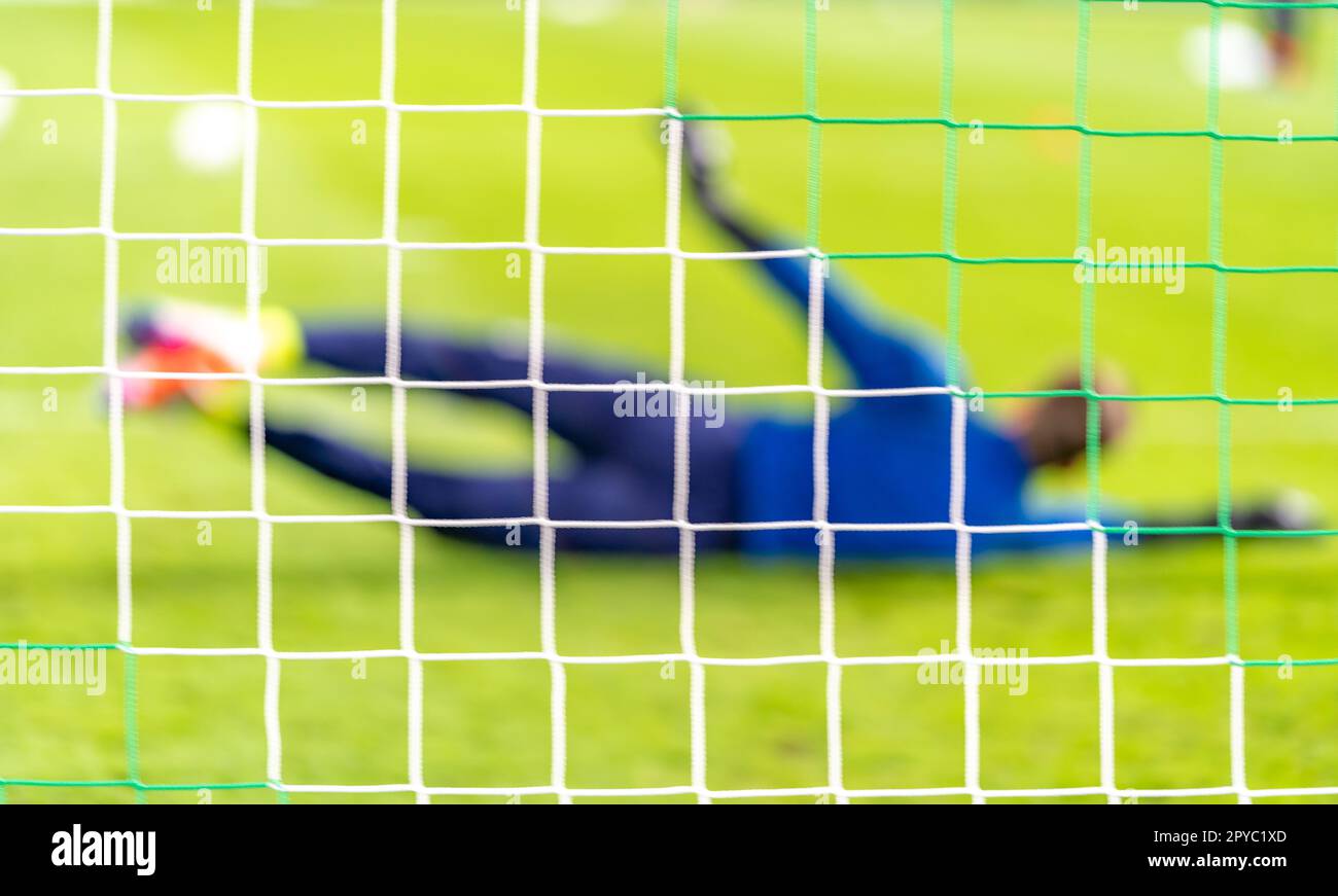 Blurred view soccer goalkeeper in the goal Stock Photo - Alamy