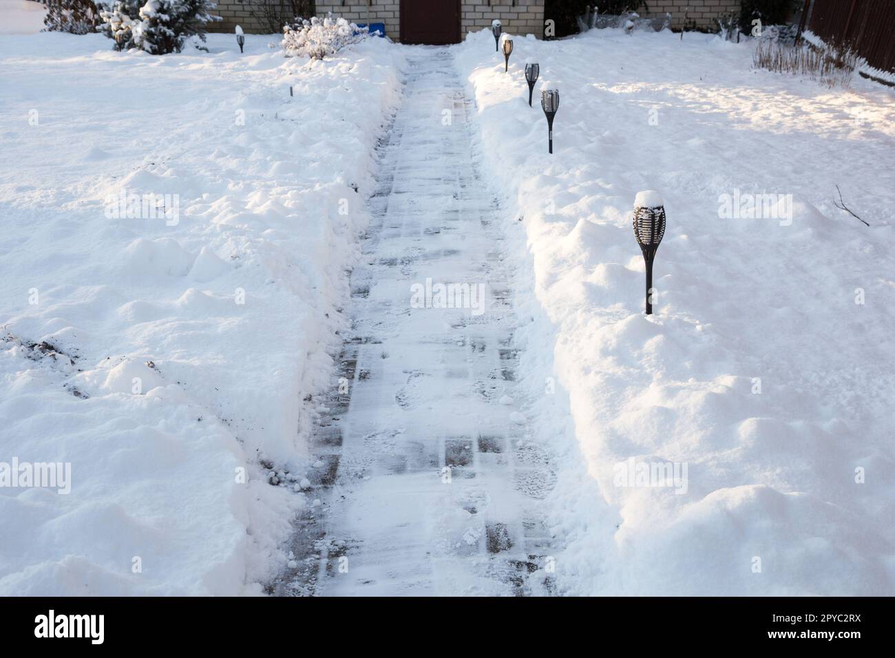 Freshly fallen snow cleared from path Stock Photo - Alamy
