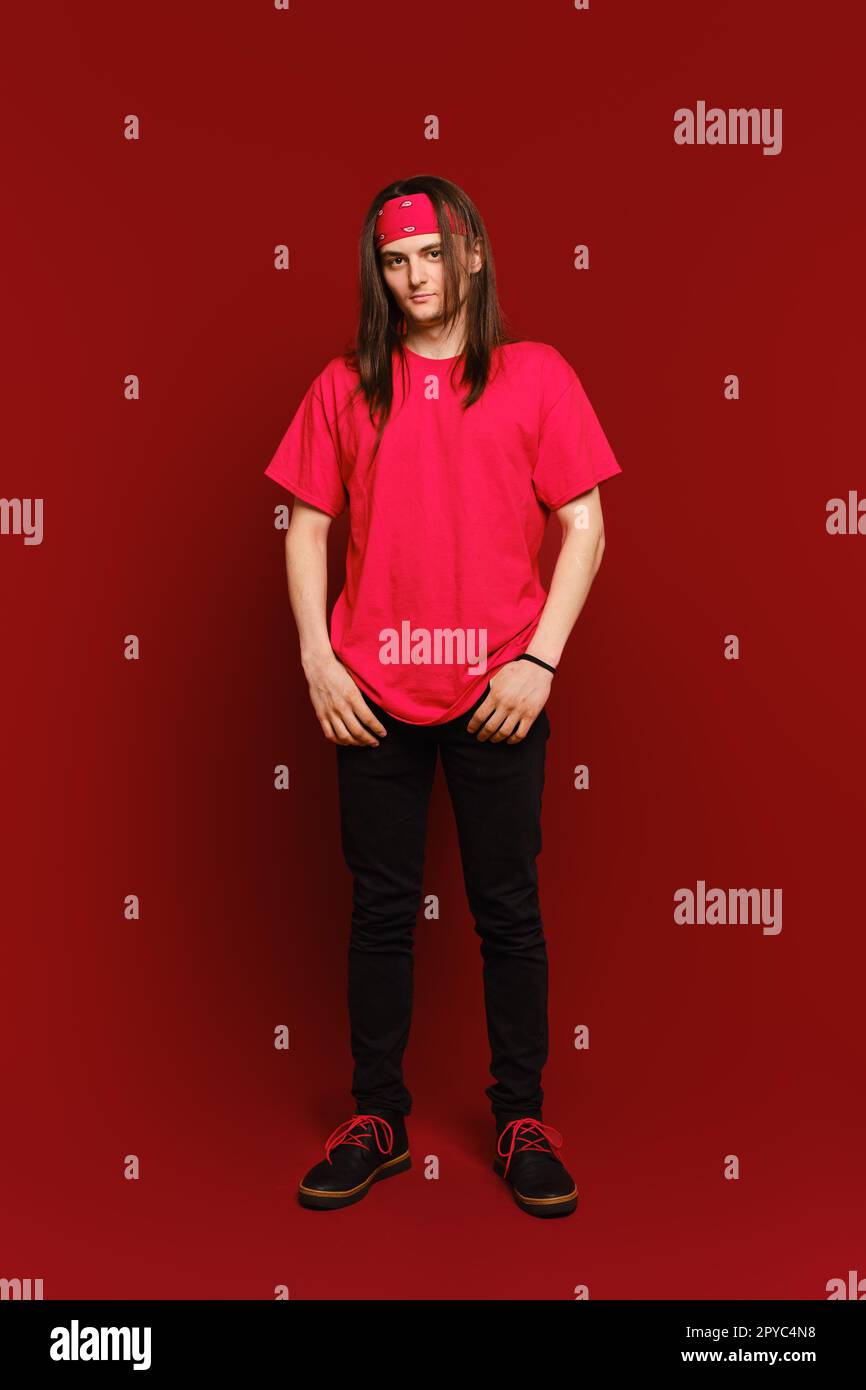 Indoor portrait of positive good-looking hipster guy wearing red band ...