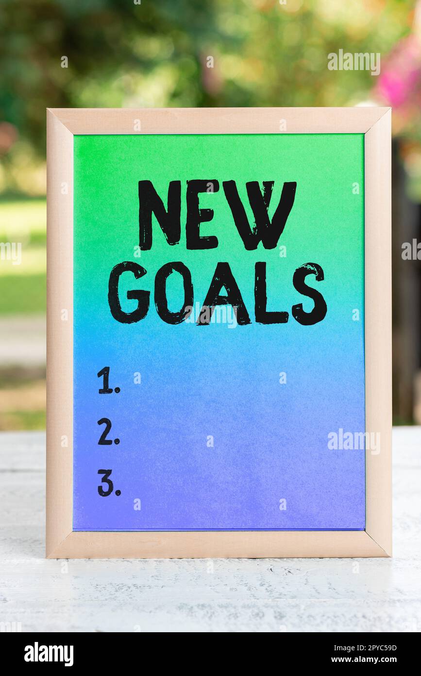 Hand writing sign New Goals. Word for a list of clearly-defined plans ...