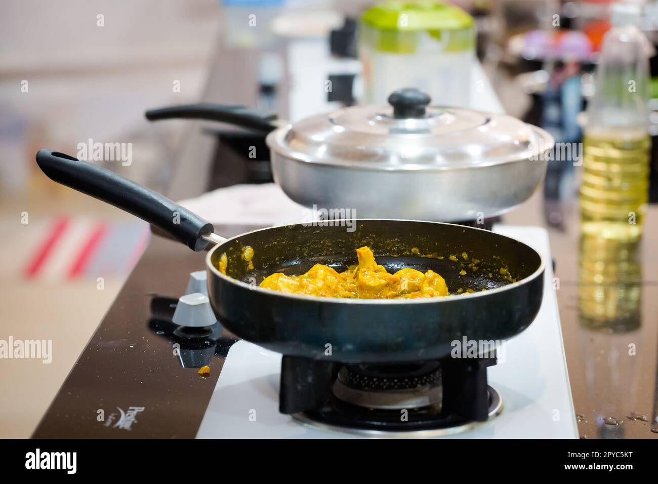 Traditional way of preparing indian food mushroom curry using gas pan ...