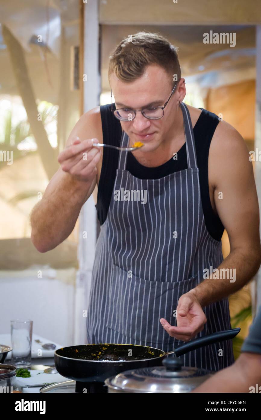 Handsome man preparing lunch hi-res stock photography and images - Alamy