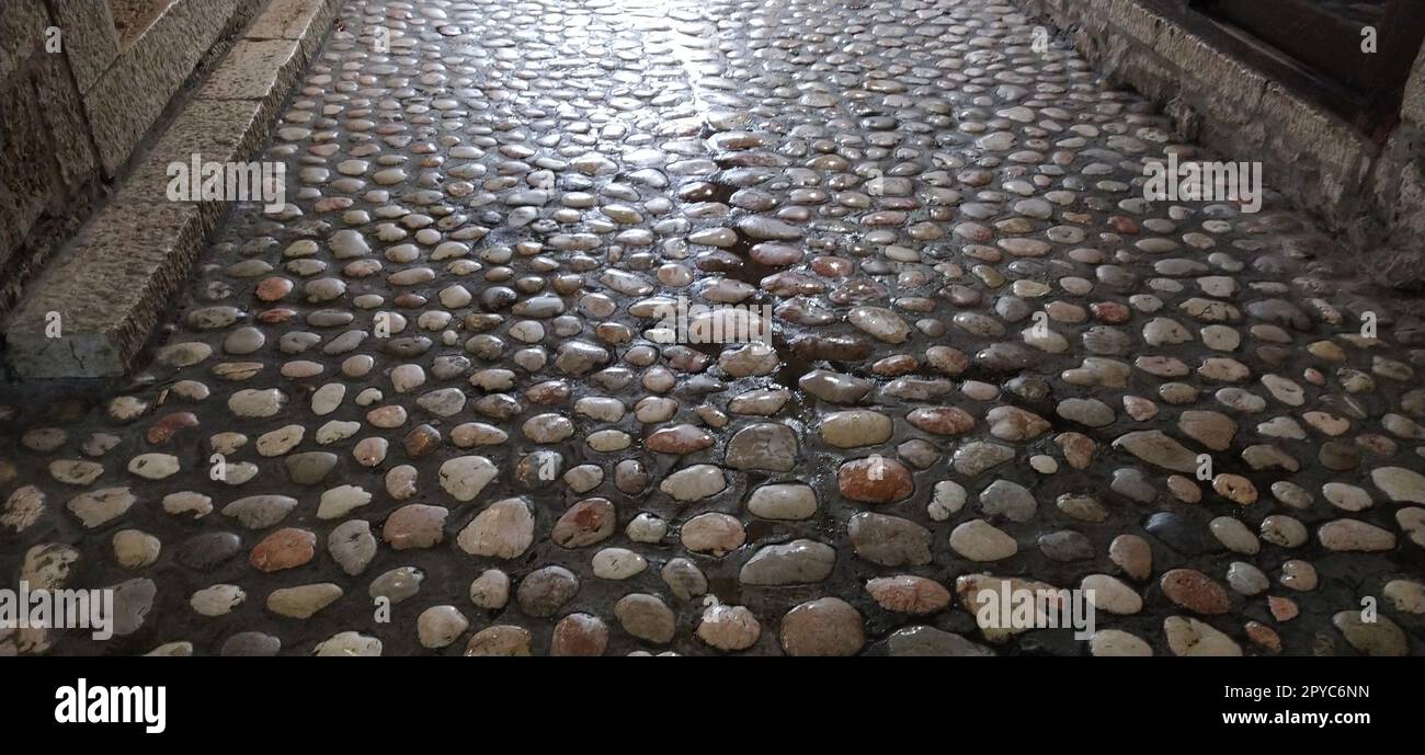 Paving stones made of round light stones similar to marble. Paved ...