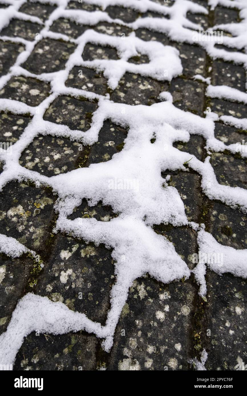 Snowy cobblestone floor Stock Photo - Alamy