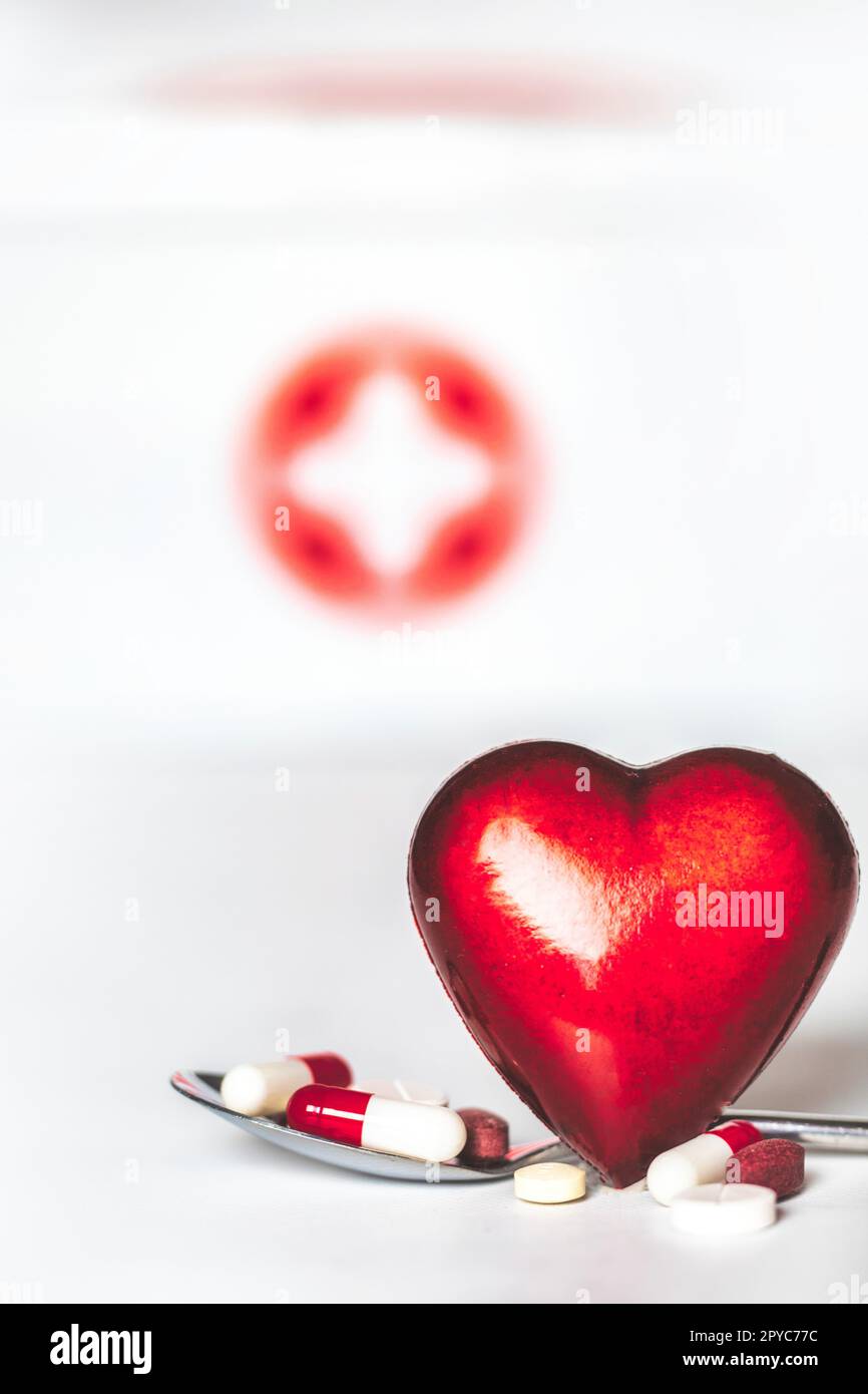 Red heart with medication pills isolated on white background, concept ...