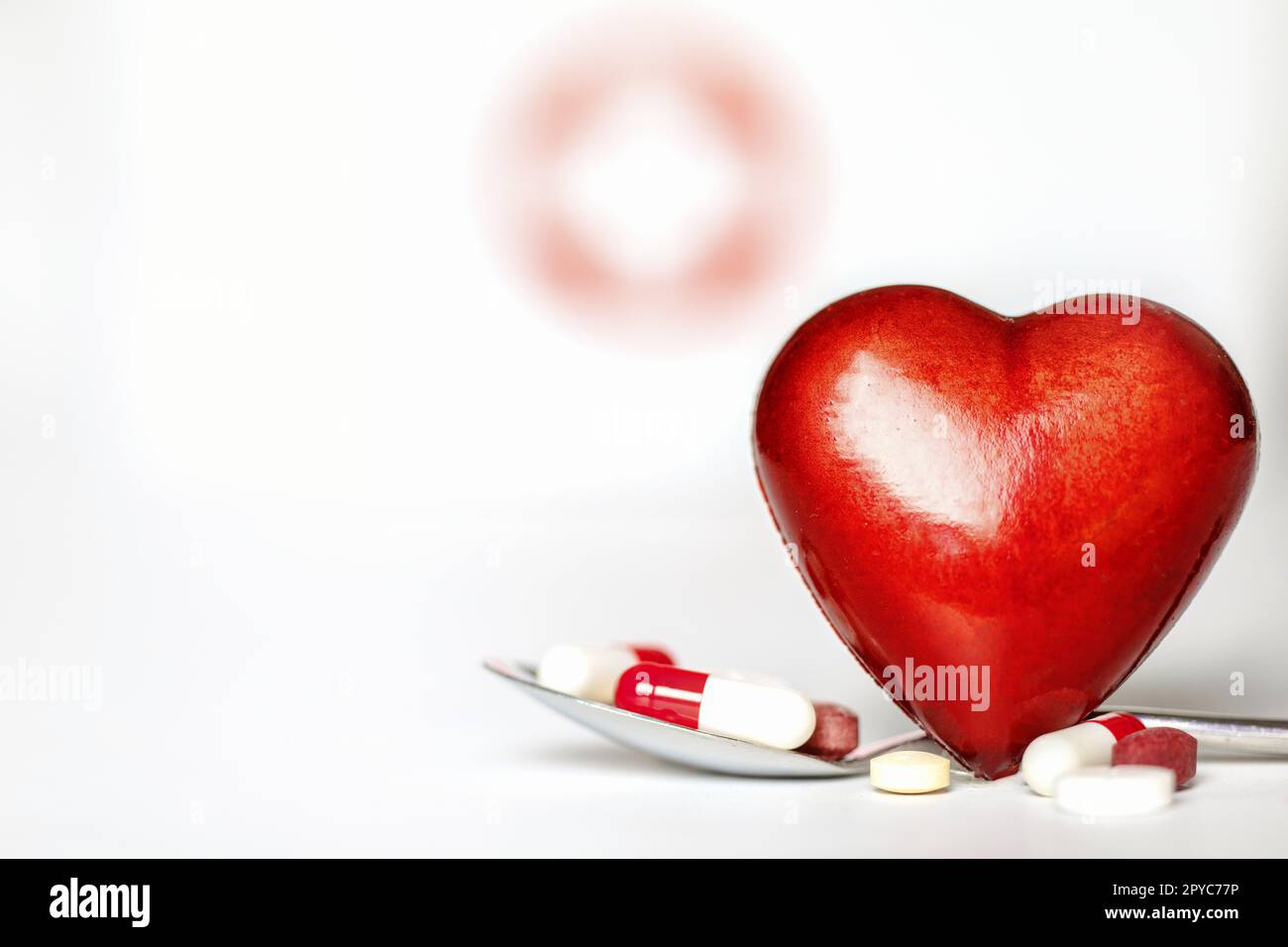 Red heart with medication pills isolated on white background, concept ...