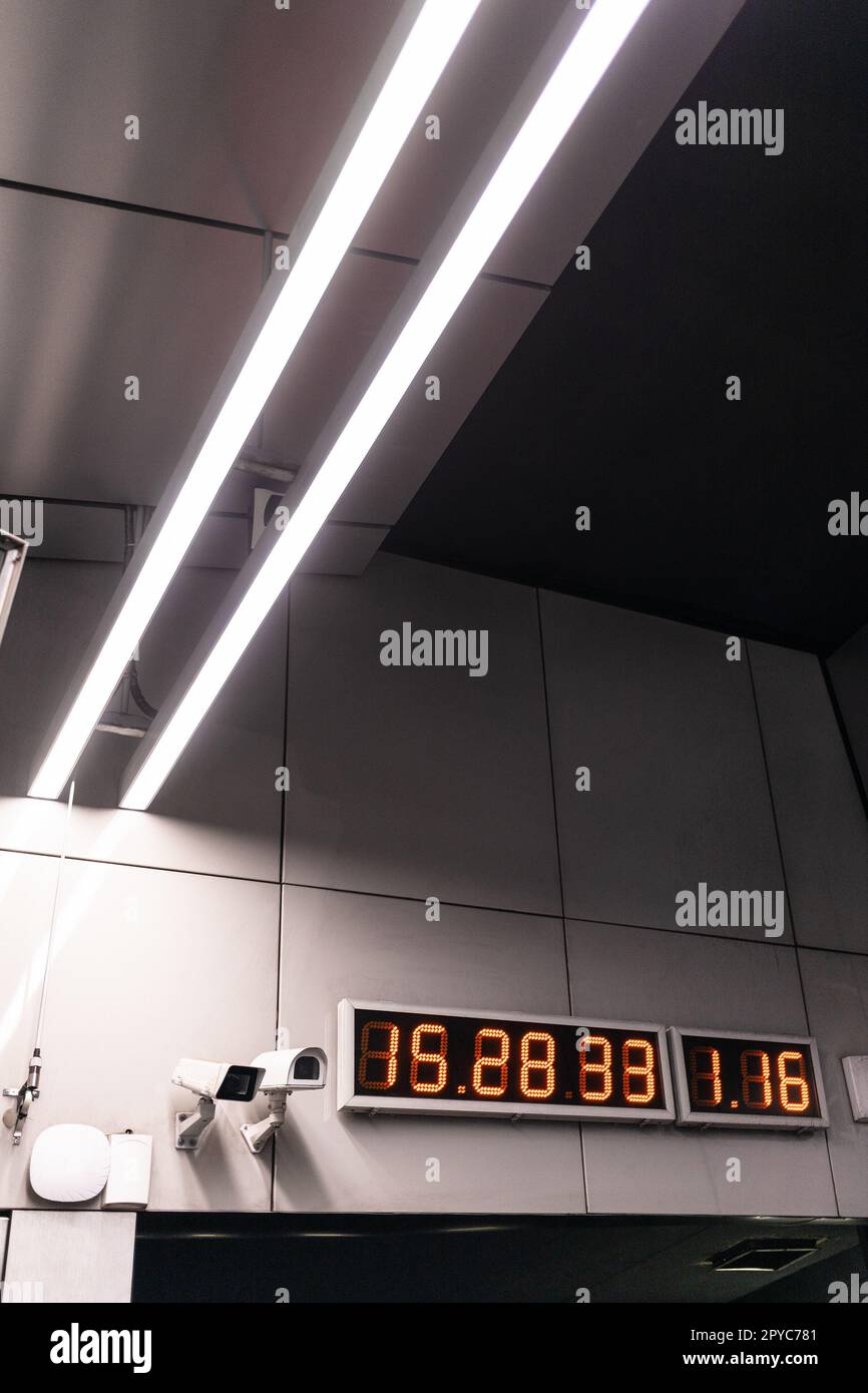 digital clock and surveillance cctv camera on wall Stock Photo - Alamy