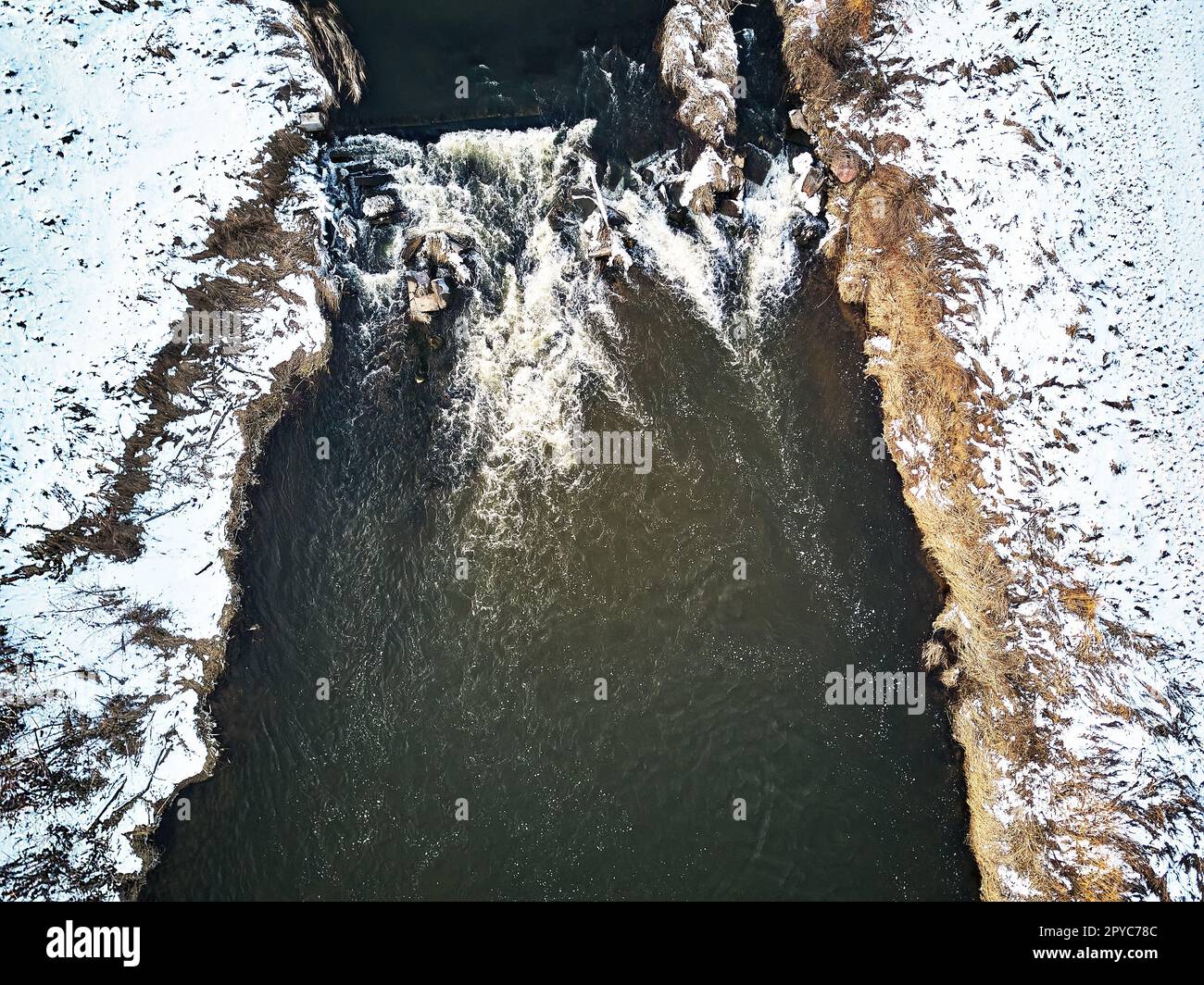 Waterfall on winter creek. Snow on frozen riverbanks. Top Aerial View ...