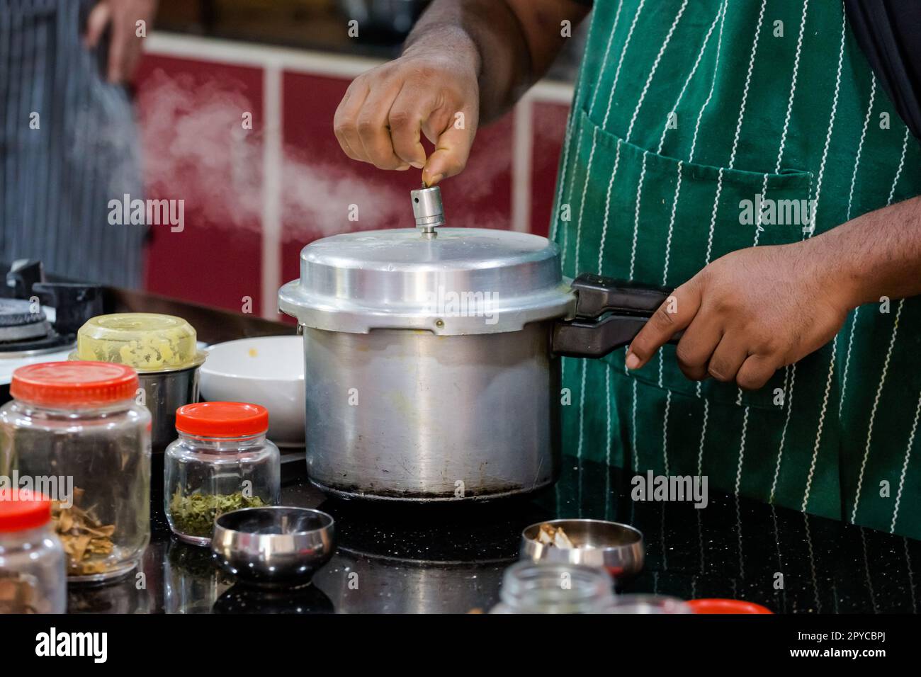 Traditional way of preparing indian food aloo gobi (potatoes with ...