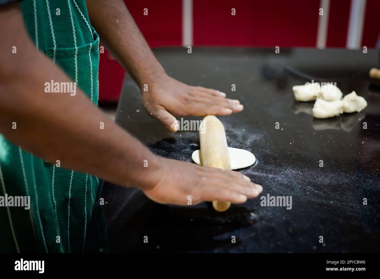 Traditional way of preparing indian food, making roti bread. Picture of ...