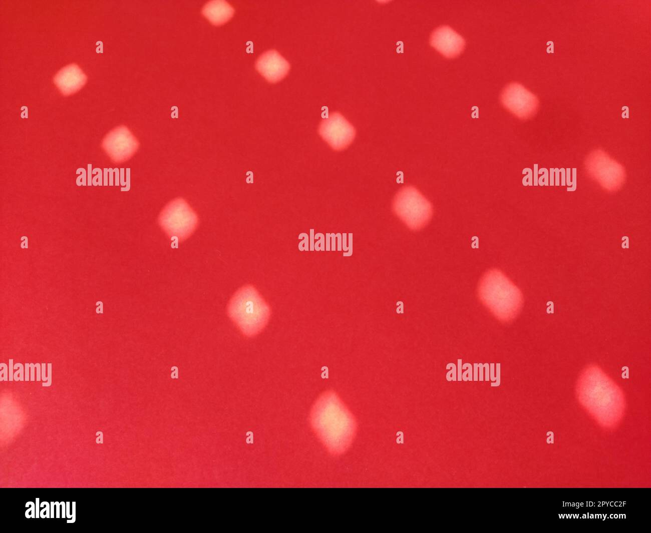 Red background with polka dots. Rays of the sun shining through the ...